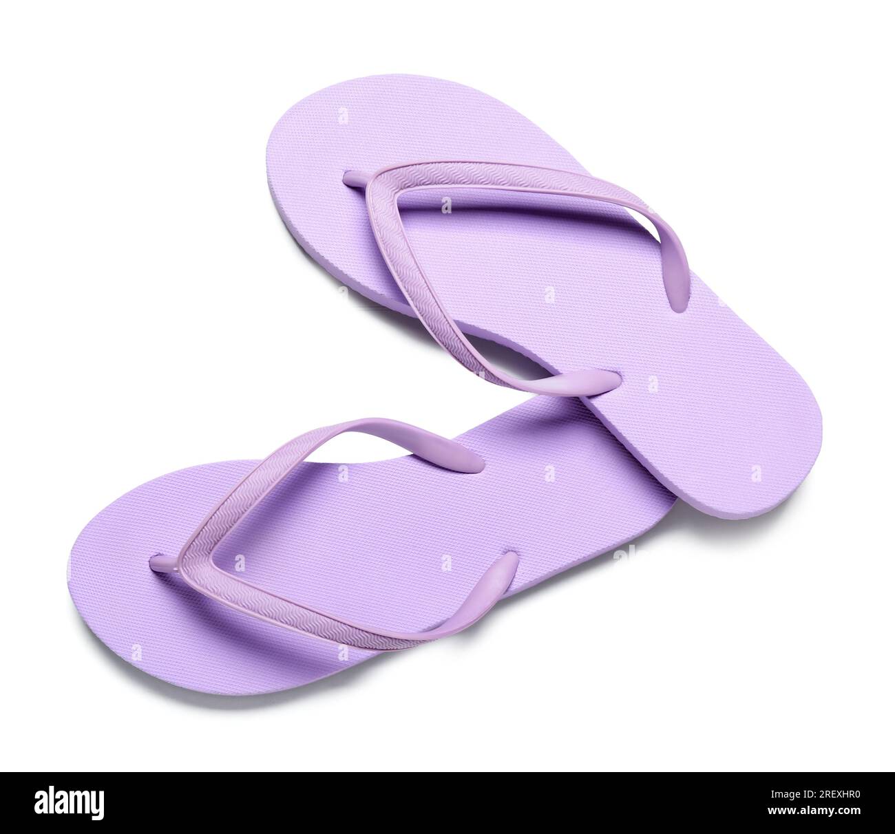 Pair of lilac flip-flops on white background Stock Photo - Alamy