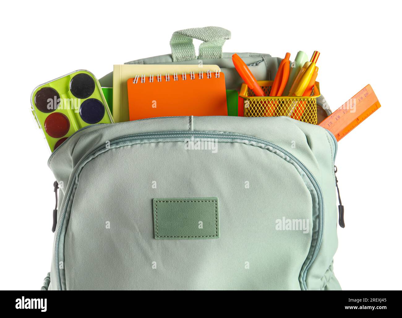 Green school backpack with different stationery on white background ...