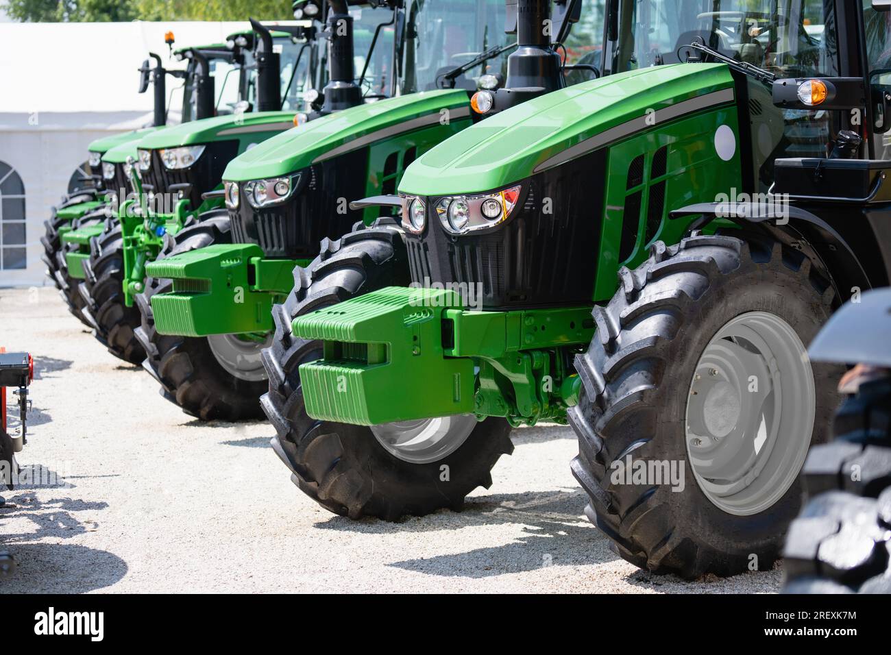 A row of green agricultural tractors Stock Photo - Alamy