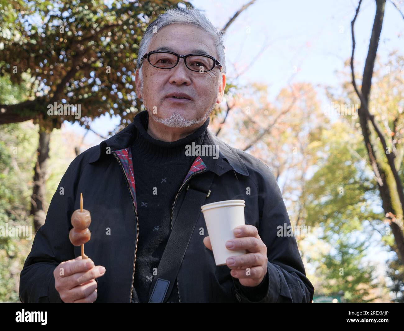 An older Japanese man eating dango and drinking coffee Stock Photo - Alamy