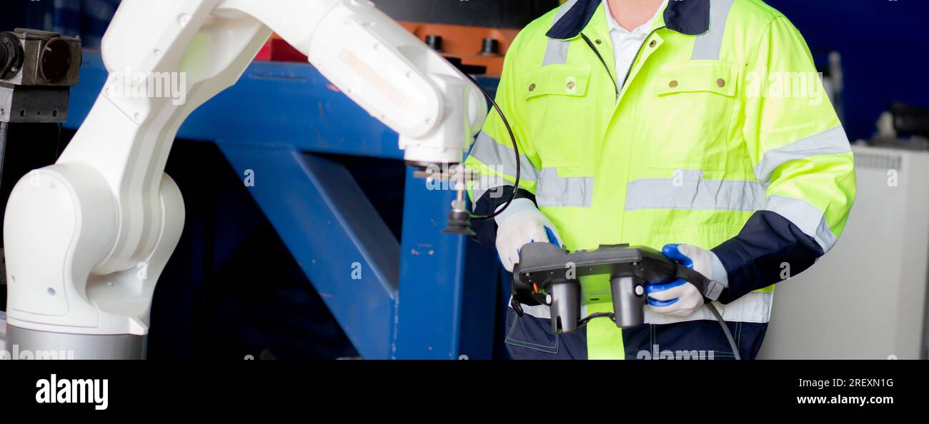 Young engineer man checking and maintenance machine robot arms ...
