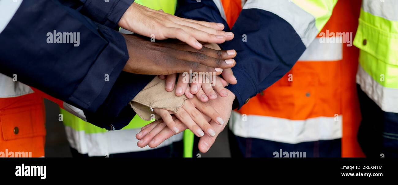 Closeup group of engineer team harmonious with hands stack for goal and ...
