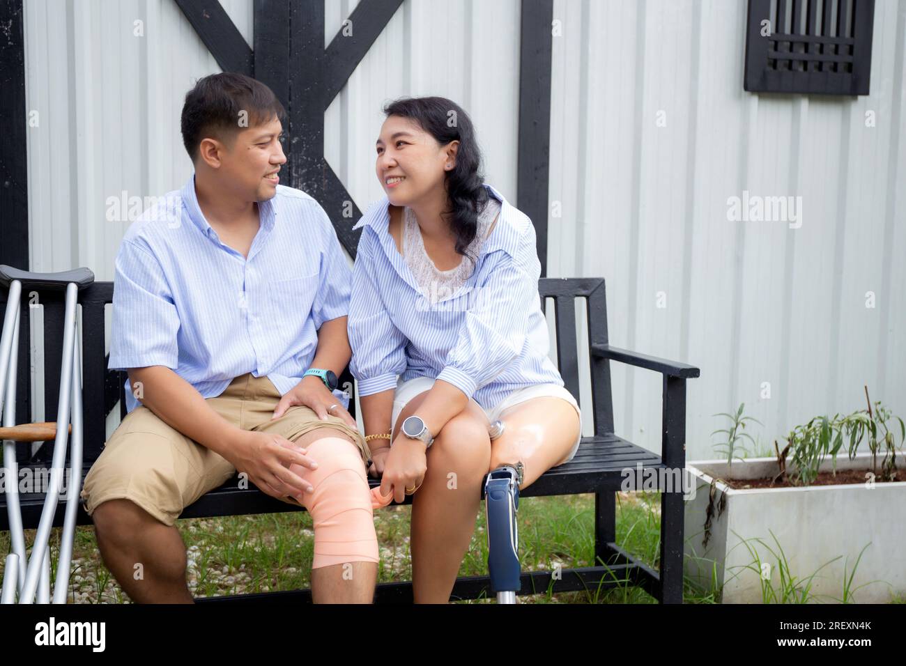 Young asian couple disabled take care while woman applying bandage with ...