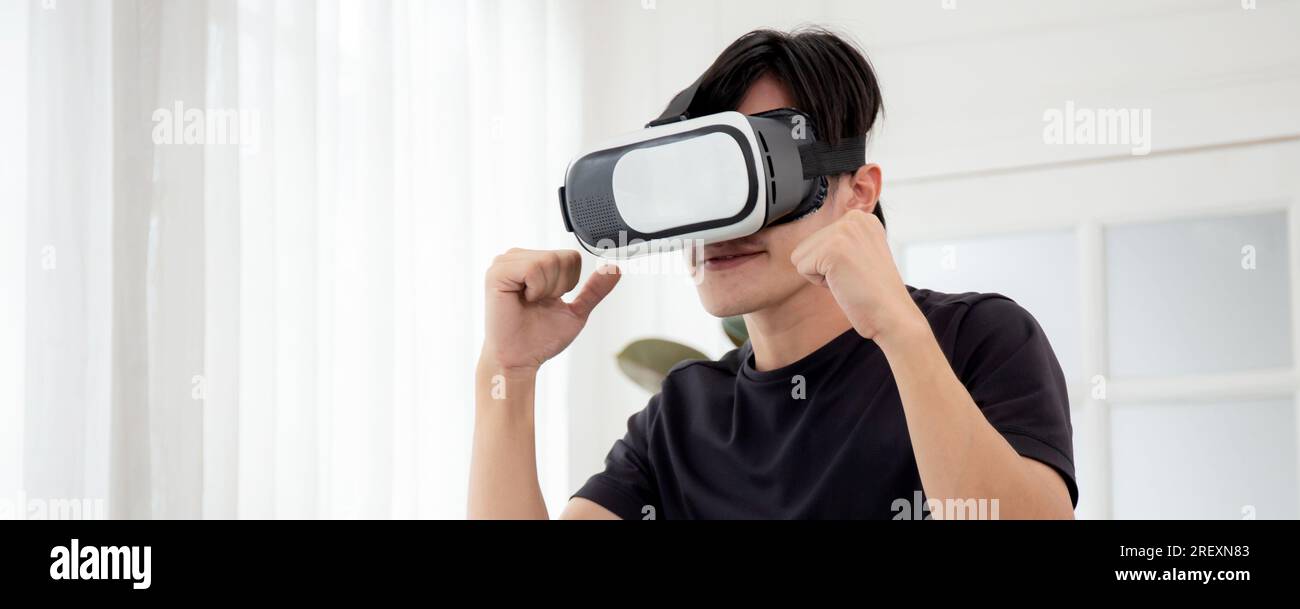 Young asian man wearing vr headset while workout and exercise at living ...