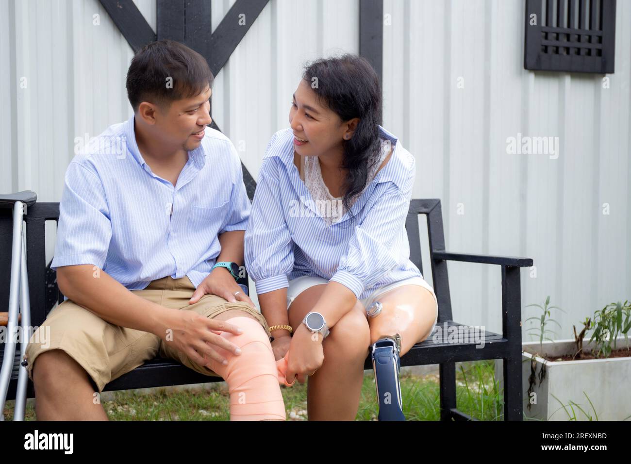 Young asian couple disabled take care while woman applying bandage with ...