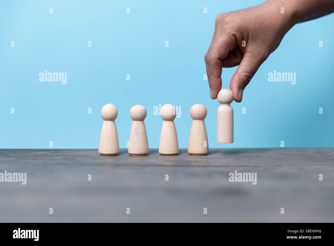 Building a strong team, Wooden blocks with people icon on blue ...