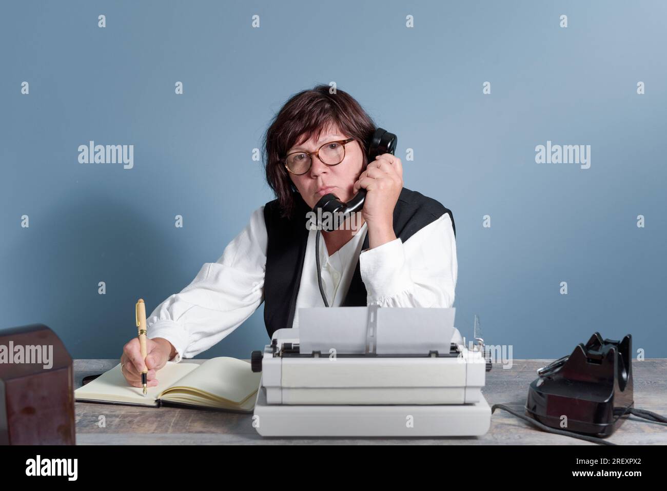 A secretary woman from the past at work. Vintage concept. Table with ...
