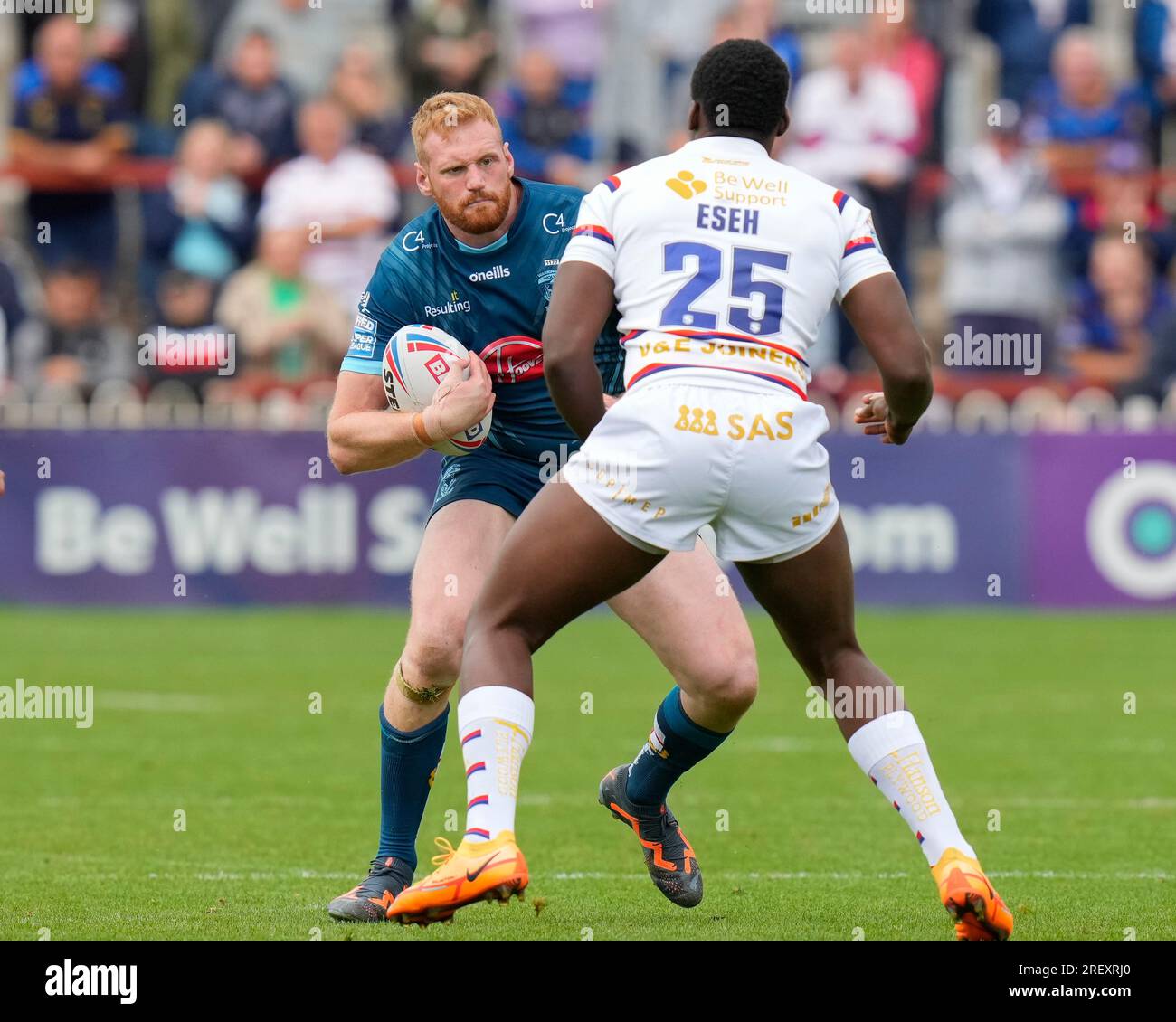 Joe Bullock #19 of Warrington Wolves runs at Sam Eseh #25 of Wakefield ...