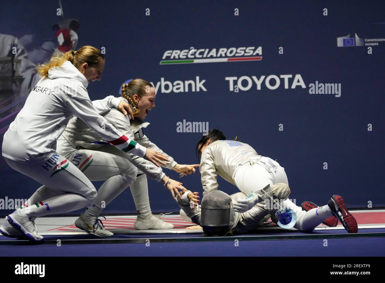 Hungary's Lisa Pusztai, bototm, is cheered by teammates after winning ...