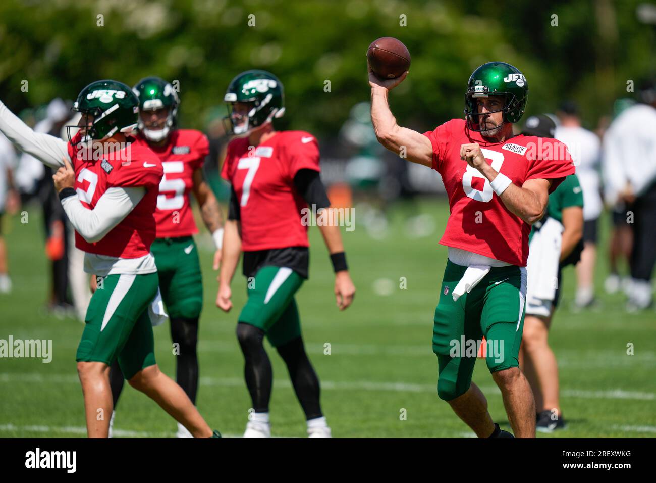 New York Jets quarterback Aaron Rodgers, right, throws during a ...