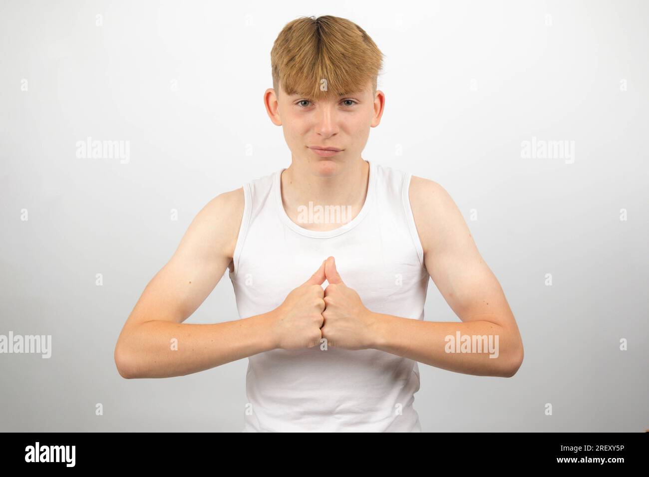 Portrait of a 14 year old caucasian teenage boy wearing a sleeveless ...