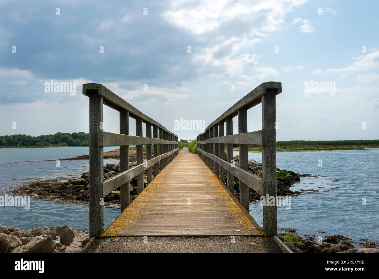 wooden footbridge across water. Perspective Stock Photo - Alamy