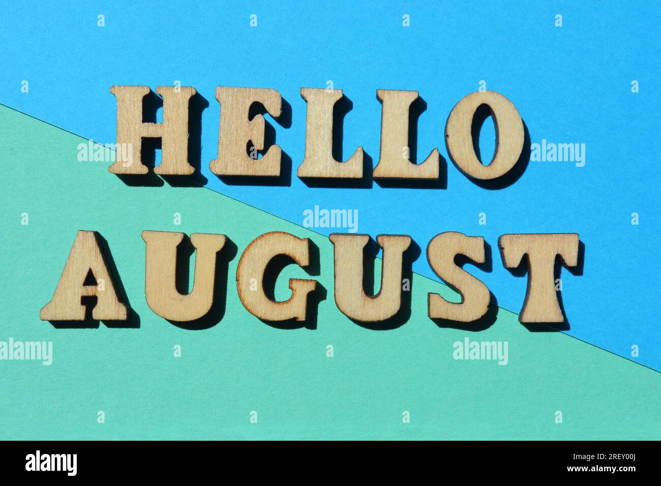 Hello August, words in wooden alphabet letters isolated on bright blue ...