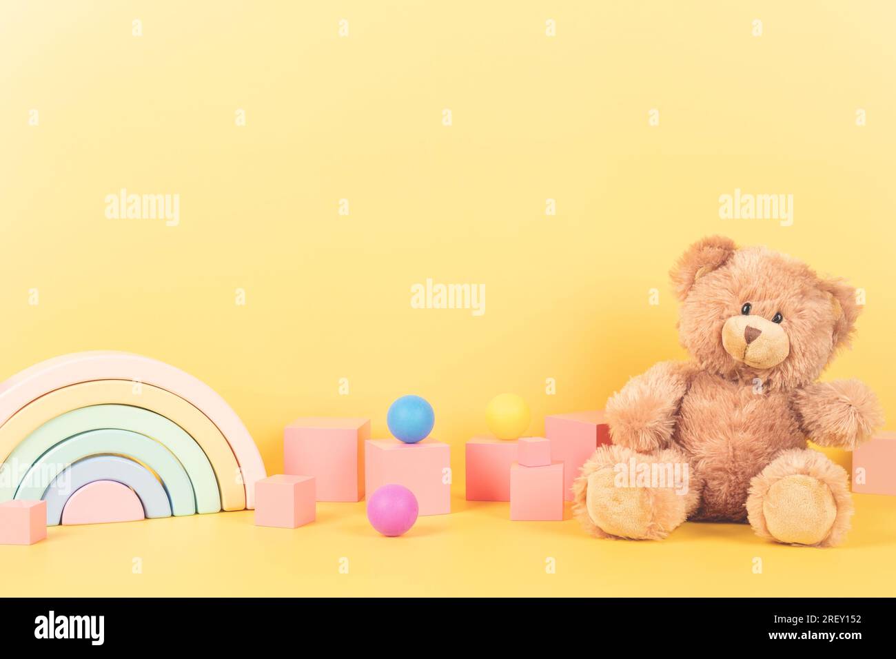 Educational kids toys collection. Teddy bear, wooden rainbow pink cubes ...