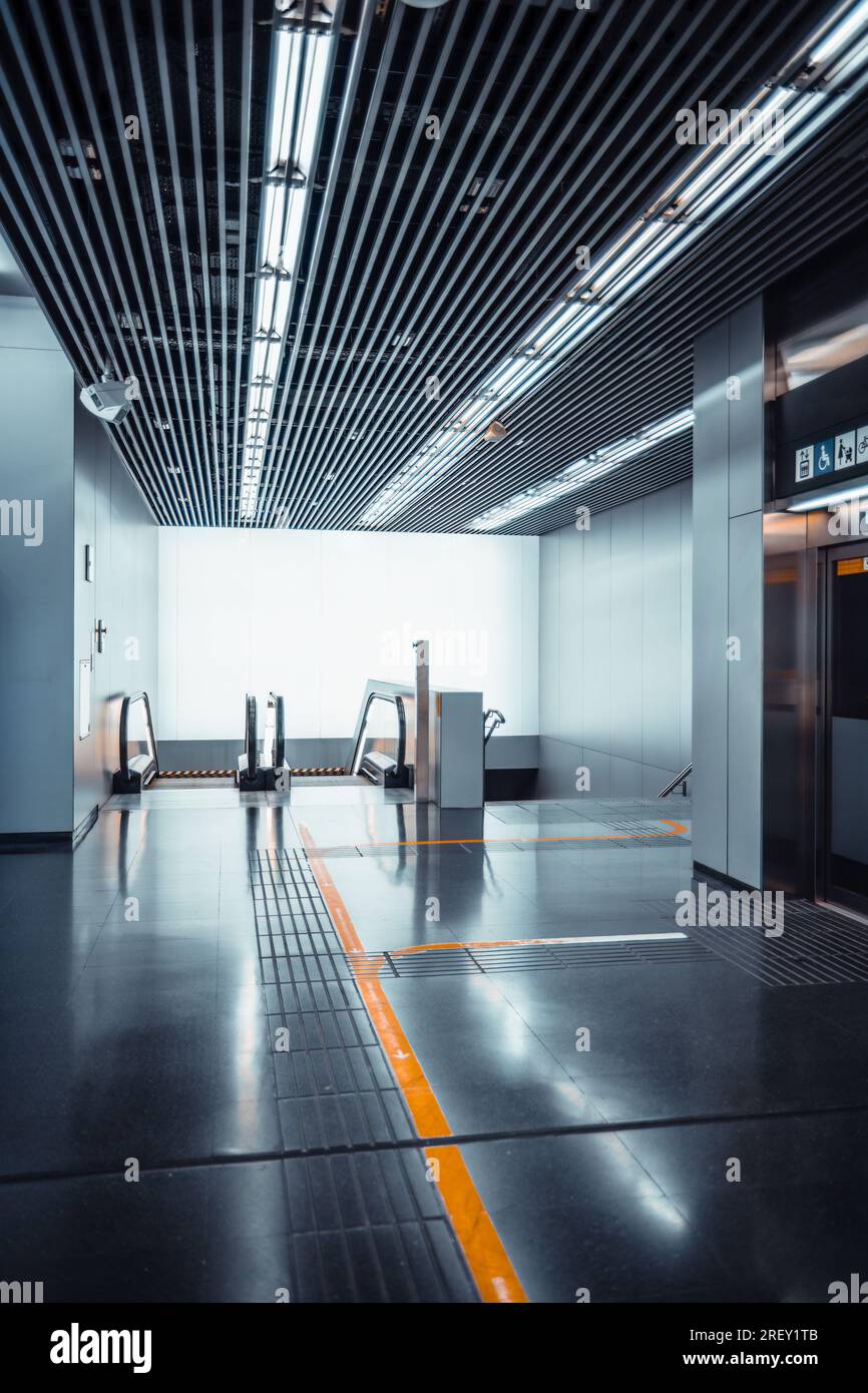 A vertical wide-angle shot of a contemporary metro entrance with ...