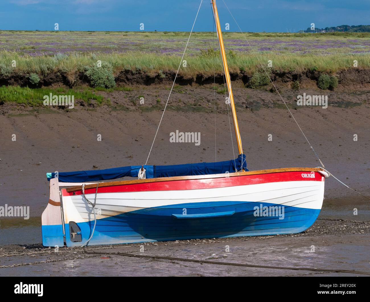 Stifle (wooden sailing dinghy) and salt marsh at low tide at Blakeney ...