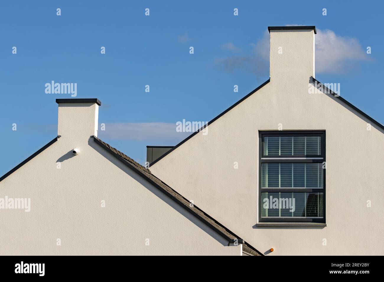 two white gables with window and video surveillance Stock Photo - Alamy