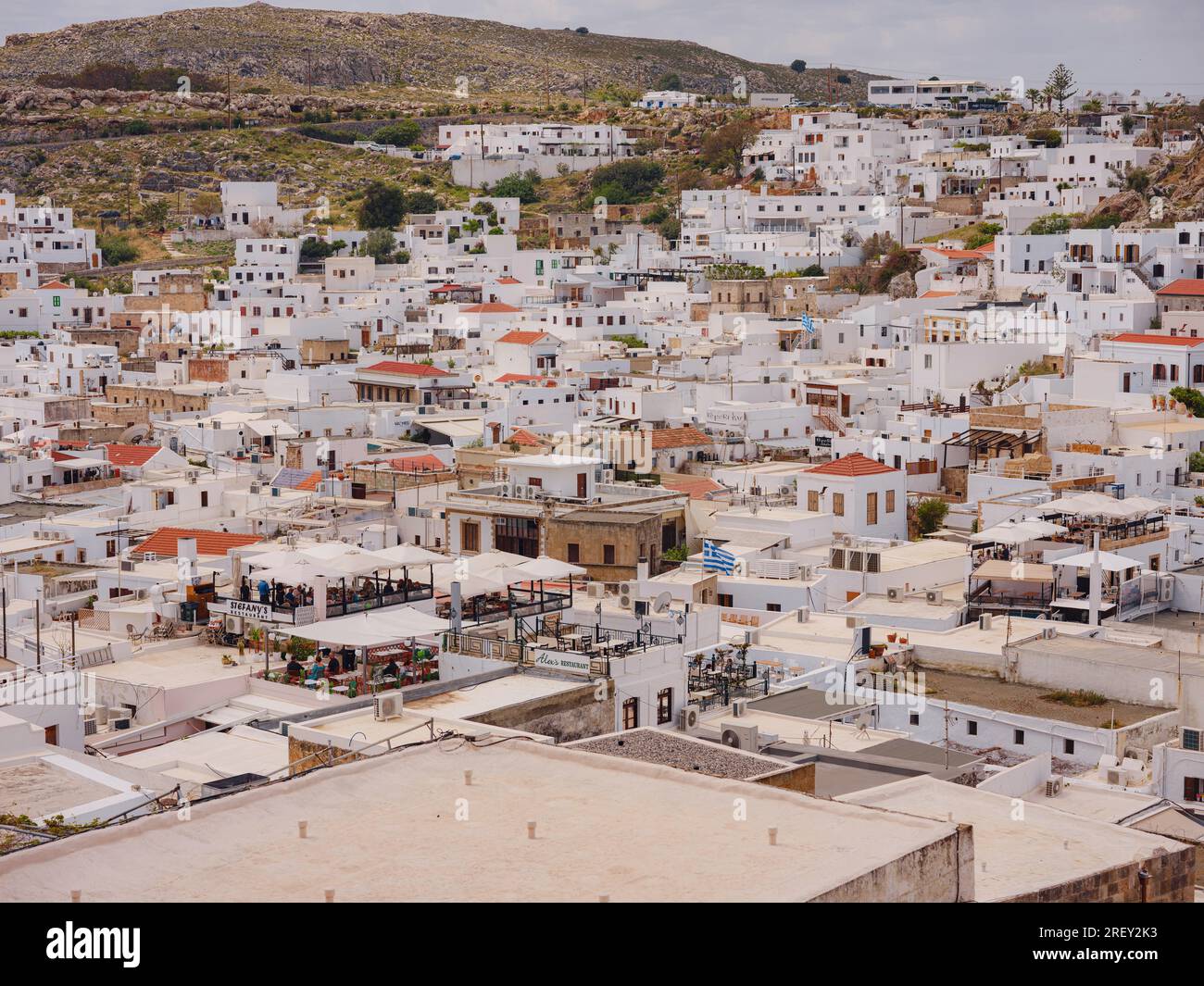 Lindos town in Greece aerial view in cloud summer day, white houses in ...