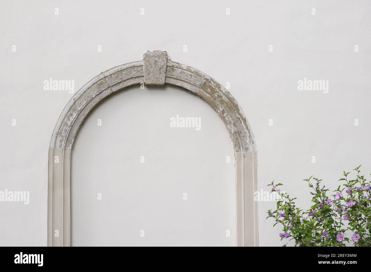 Decorative arch and semi vault above niche with stone pillars. Old ...