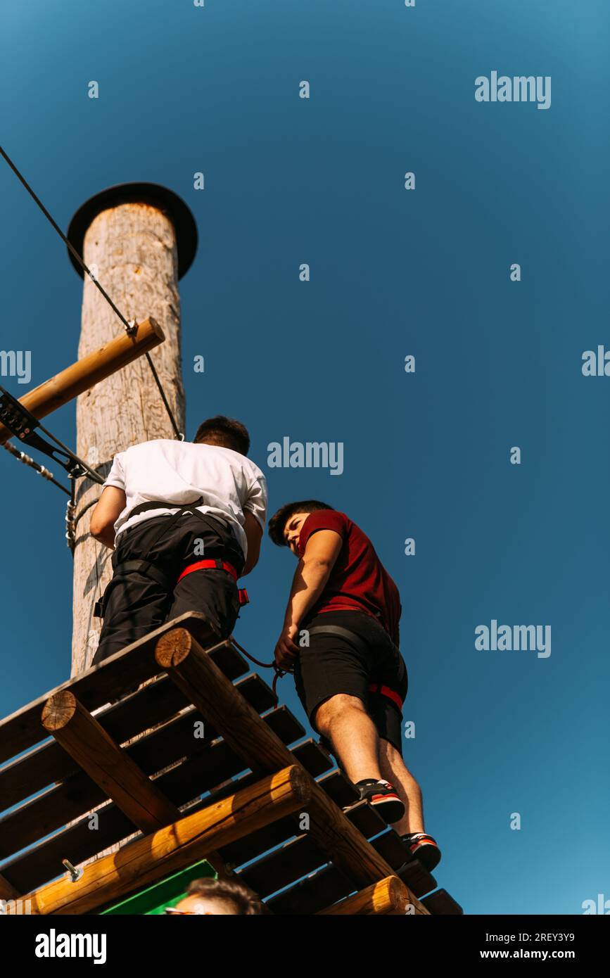 Team of skilled climbers preparing to do the hardest obstacle of them ...