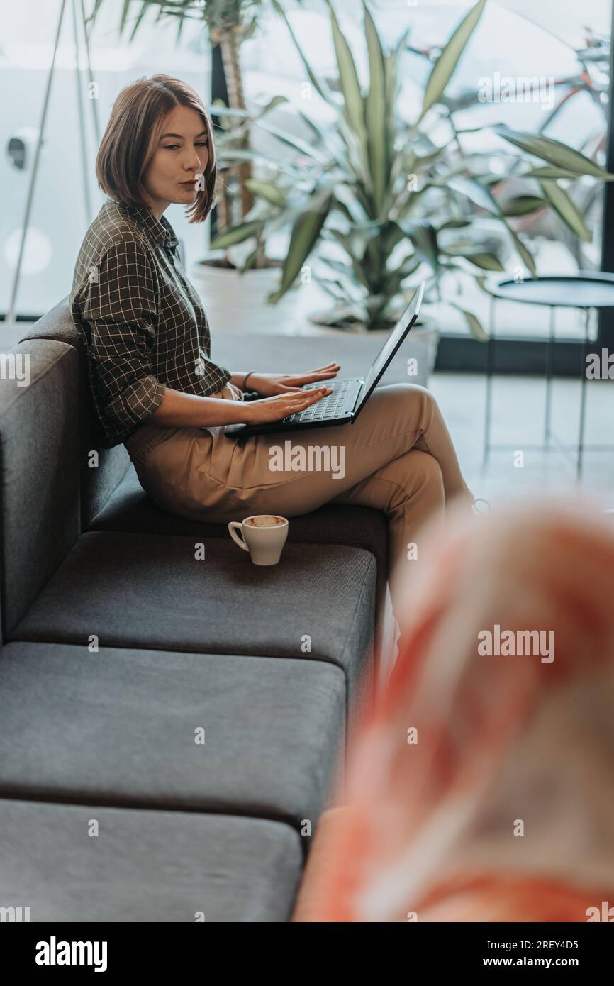 Cute short haired business girl having a morning coffee. She is working ...