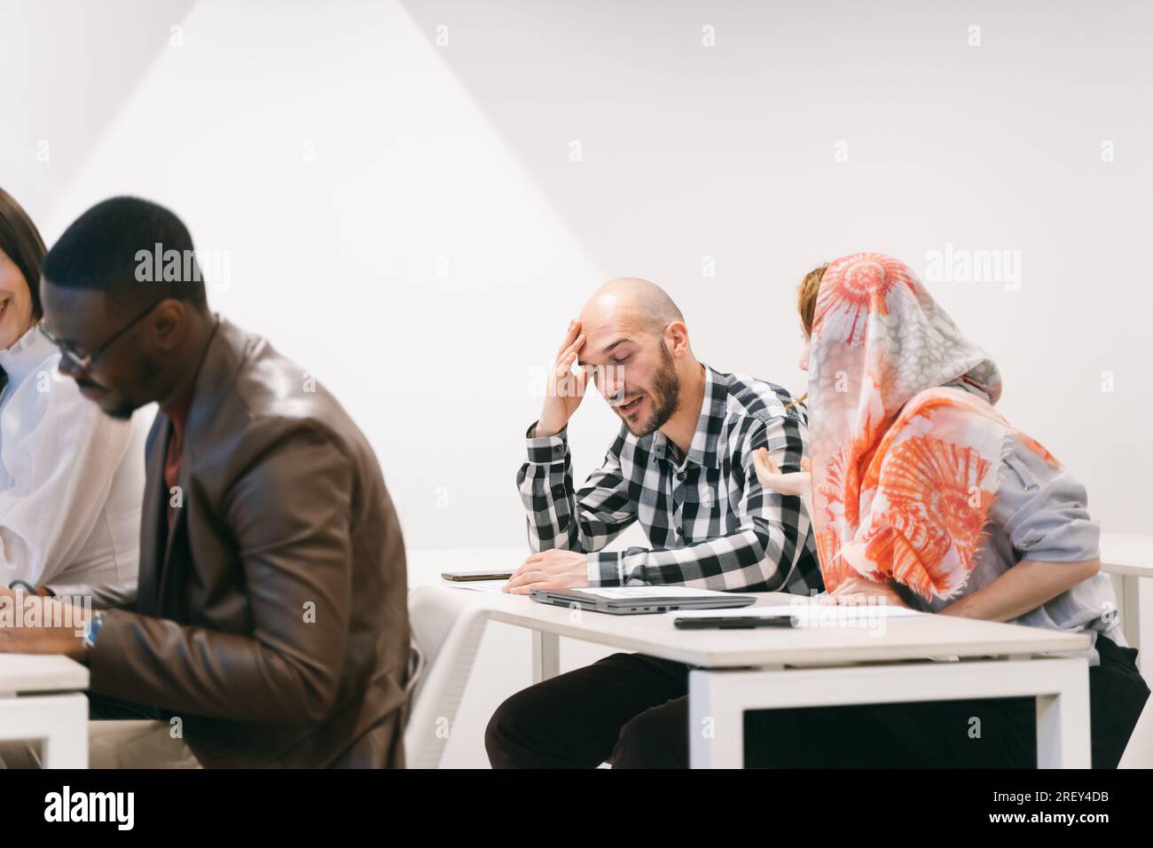 A shot of multicultural students having an exam. Muslim female student ...