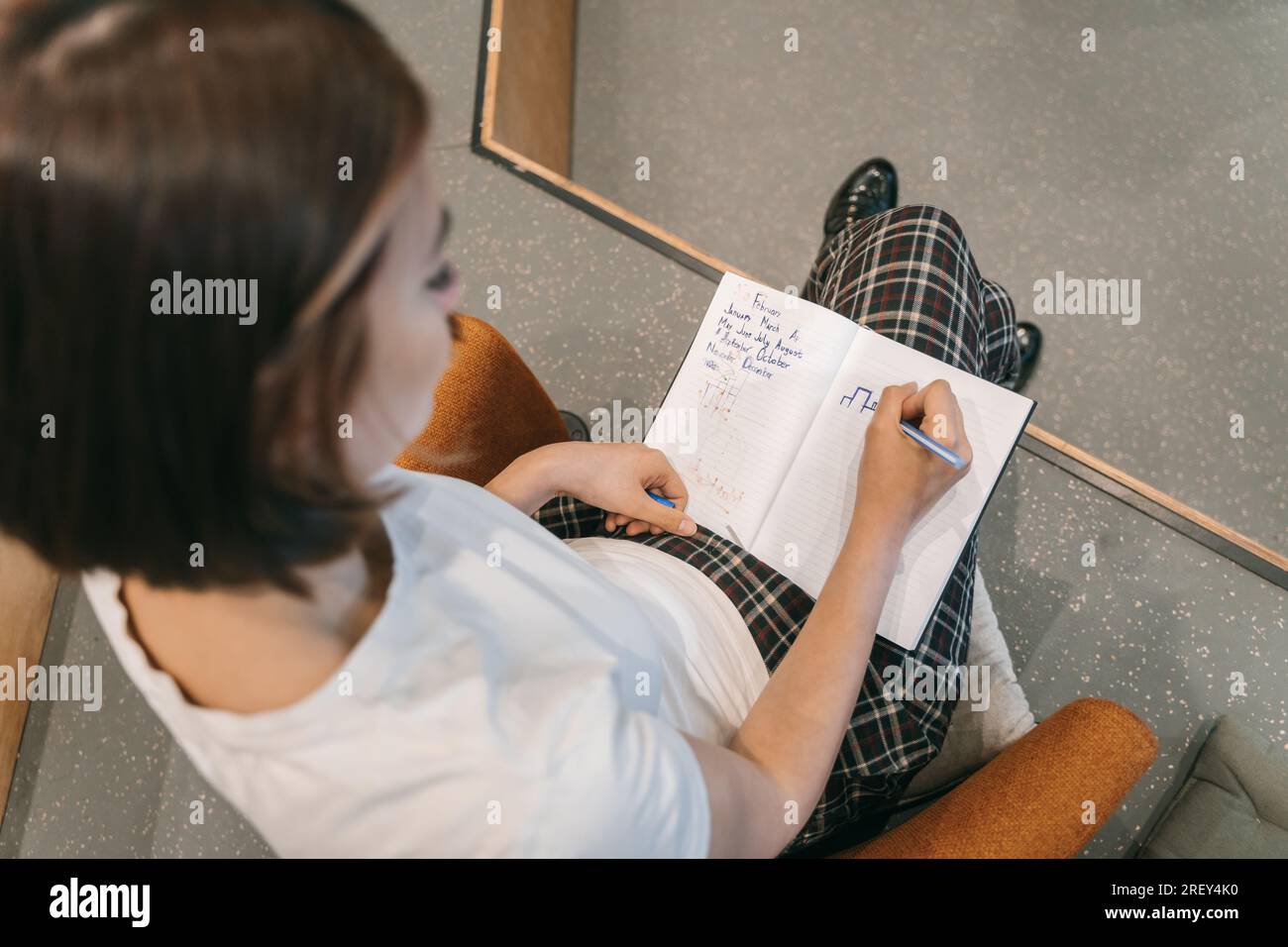 Woman taking notes while attending a lecture in a lecture hall Stock ...