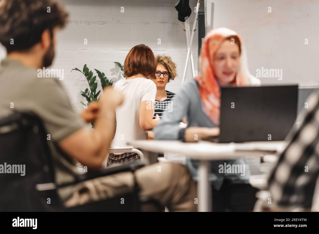 Group of diverse people communicating and working on a project in ...