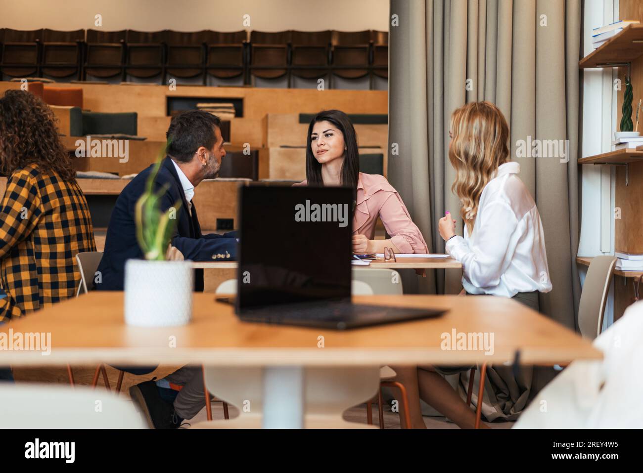 Three business colleagues working in the office cafeteria Stock Photo ...