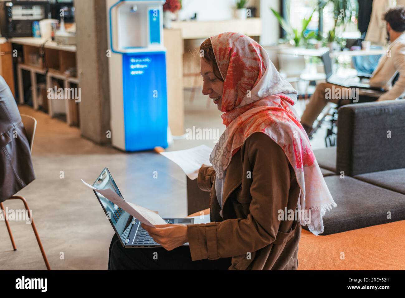 Muslim female company operator working on lap top computer analyzing ...