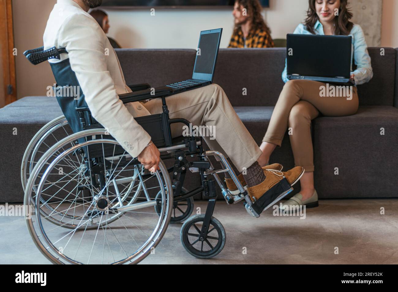 Handicapped businessman rolling wheelchair wheel at work while working ...