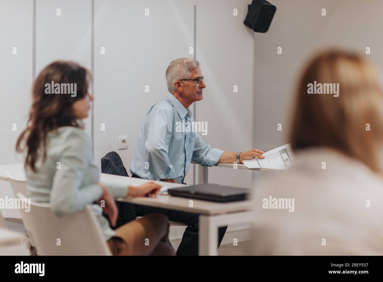 70s business owner listening to lecture for better efficiency at the ...