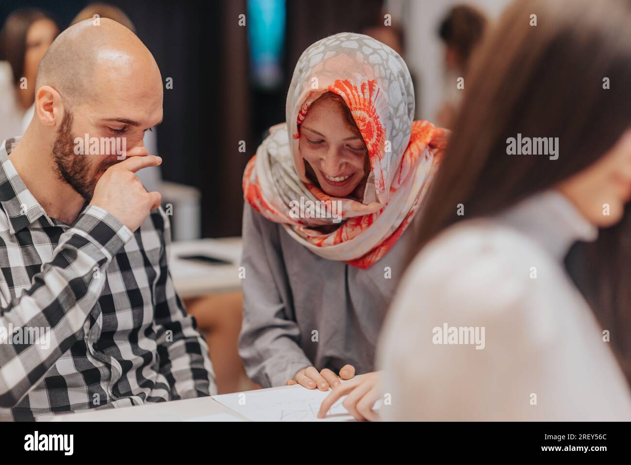 Gorgeous muslim female employee helping her male colleague at work. She ...
