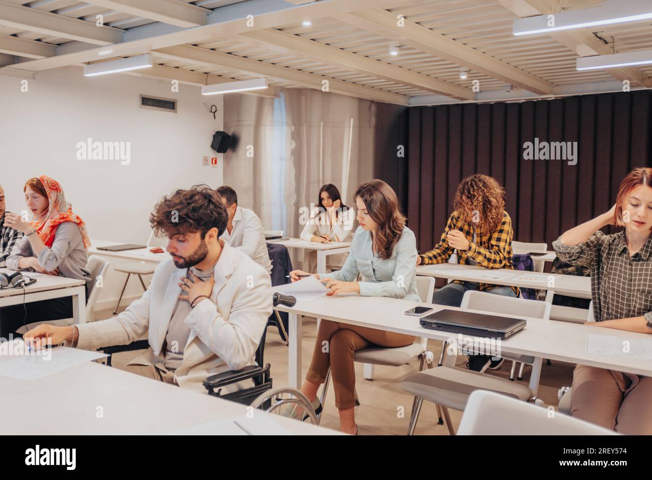 Young people having business exam after successful training at the ...