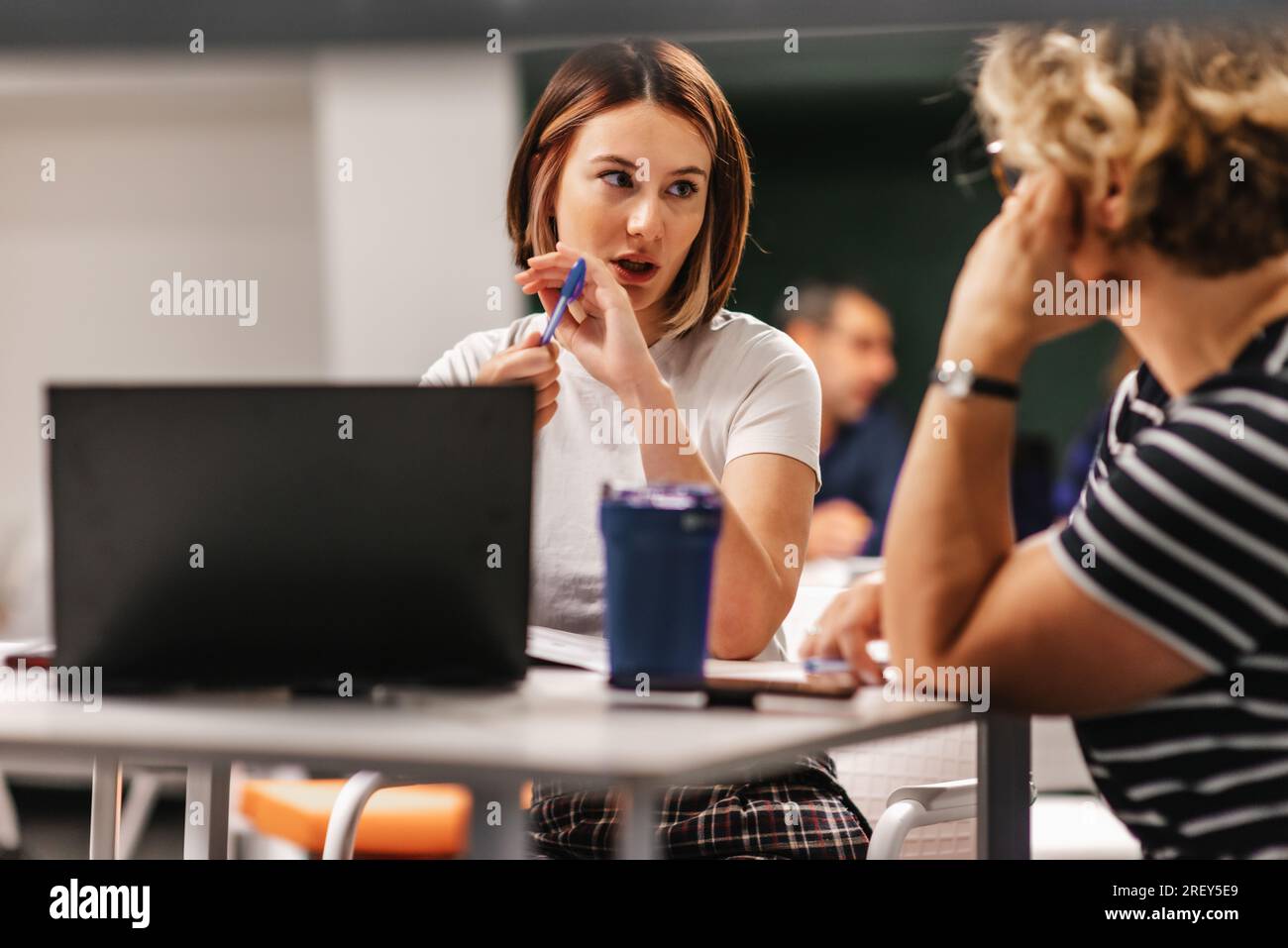 Different aged coworkers learning together, working at modern office ...