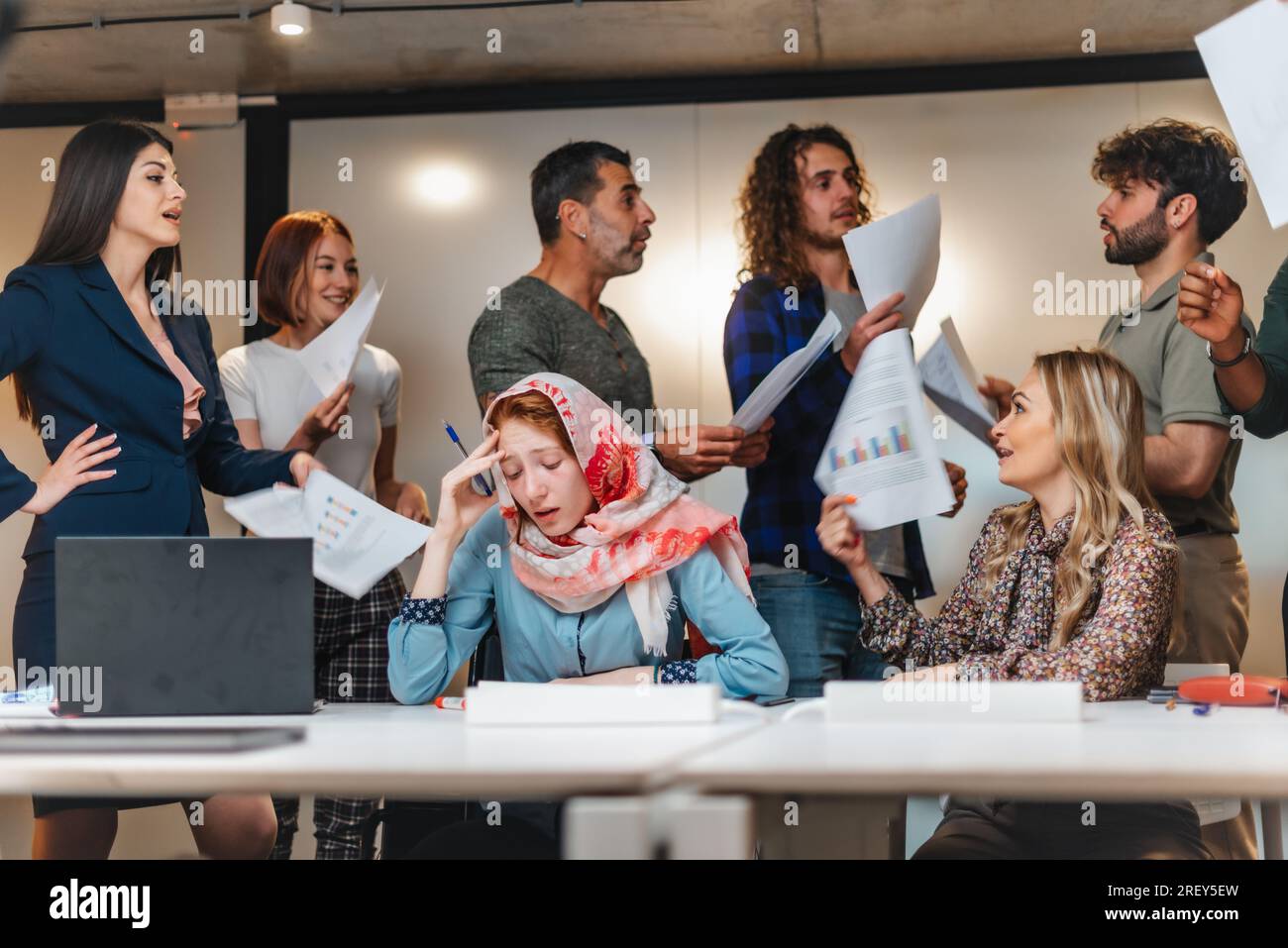 Multiracial, different aged business team arguing at company office ...