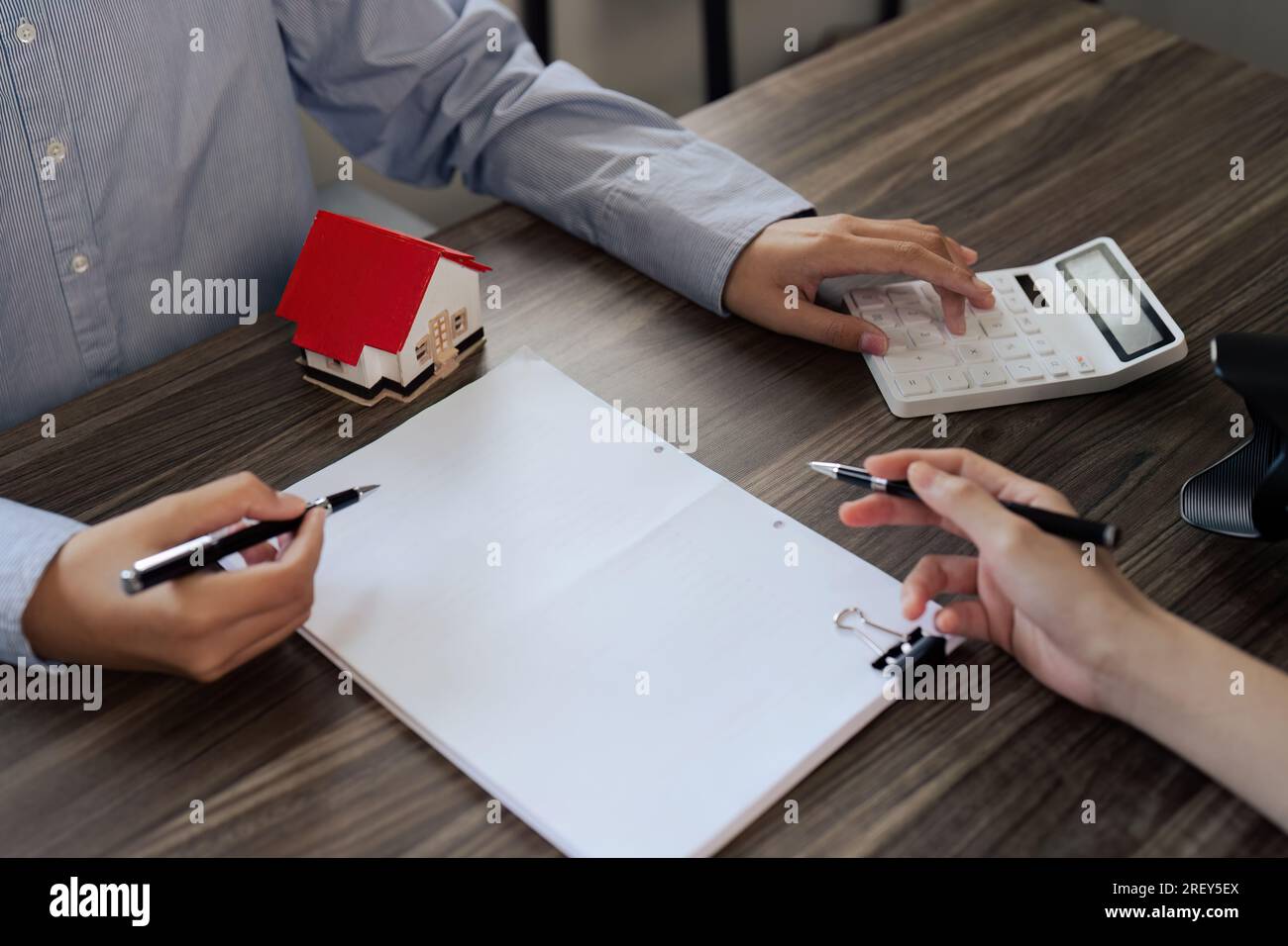 Real Estate Agent explain insurance and agreement contract to client ...