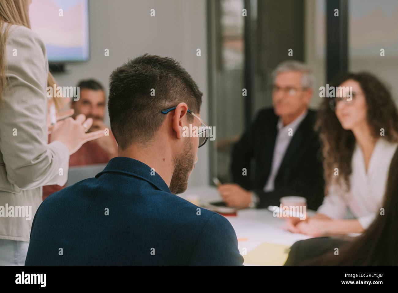 Close up of business man with dark blue suit and glasess looking down ...
