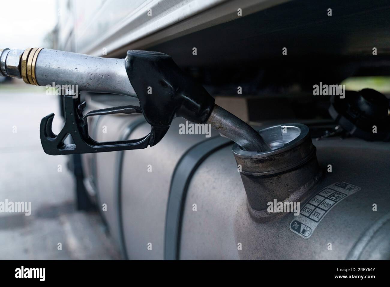 Refueling a truck. A close-up of a gas station gun inserted into the ...