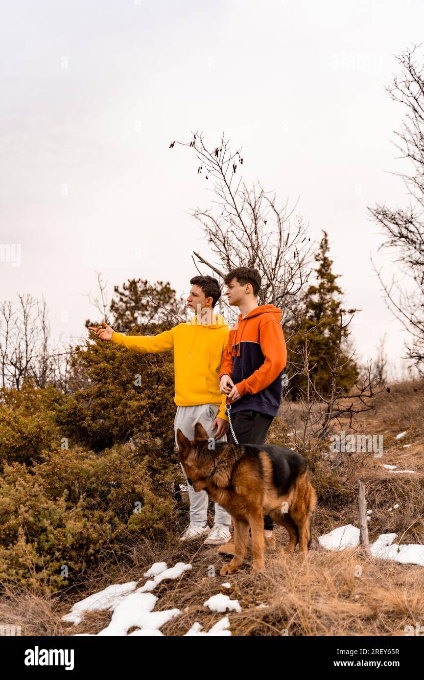 Attractive and handsome male friends are looking at the city and ...
