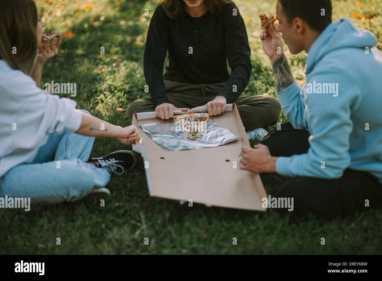 Three friends fighting about the last pizza slice while sitting at the ...