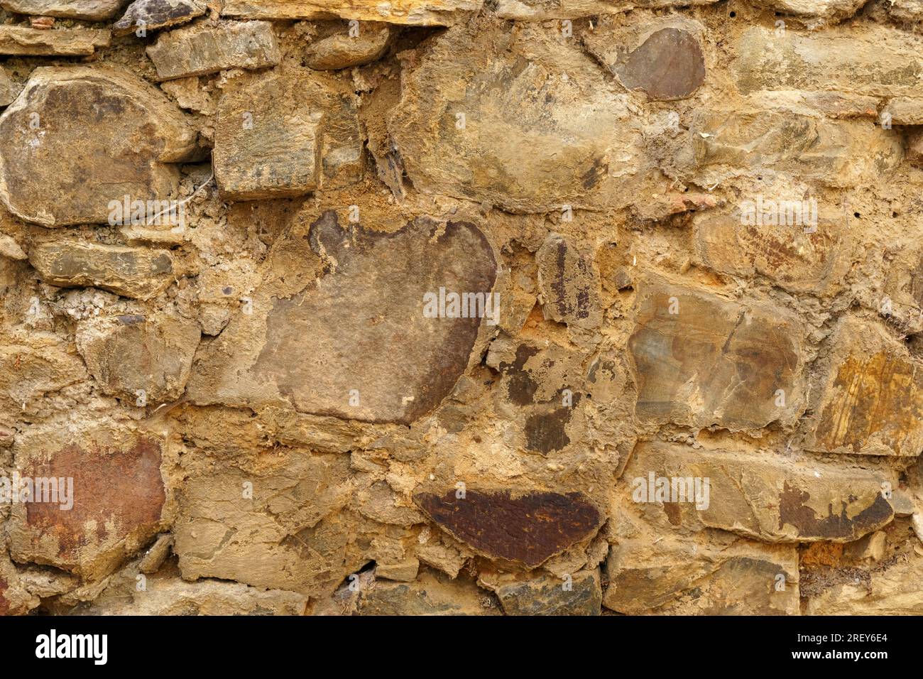 The texture of the old medieval wall of the house, lined with brown ...