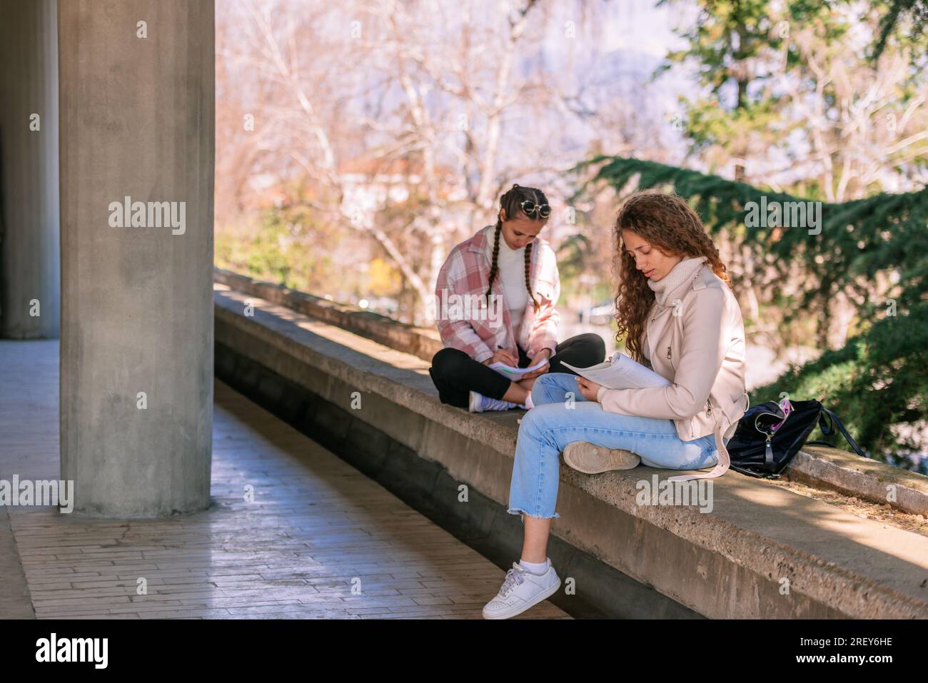 College girls studying writing outside hi-res stock photography and ...
