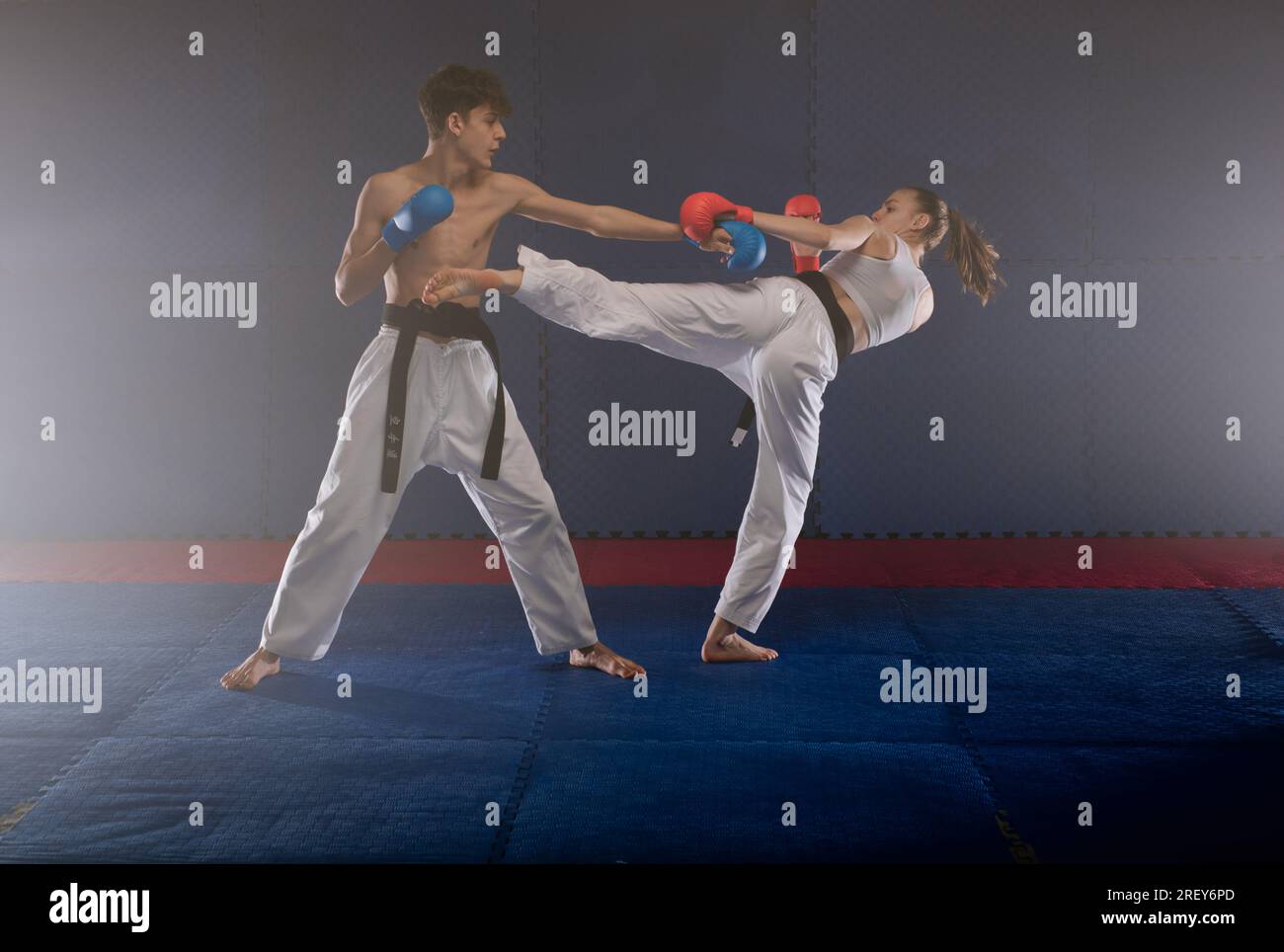 Two young and good looking karate friends doing the Ura Mawashi Geri ...