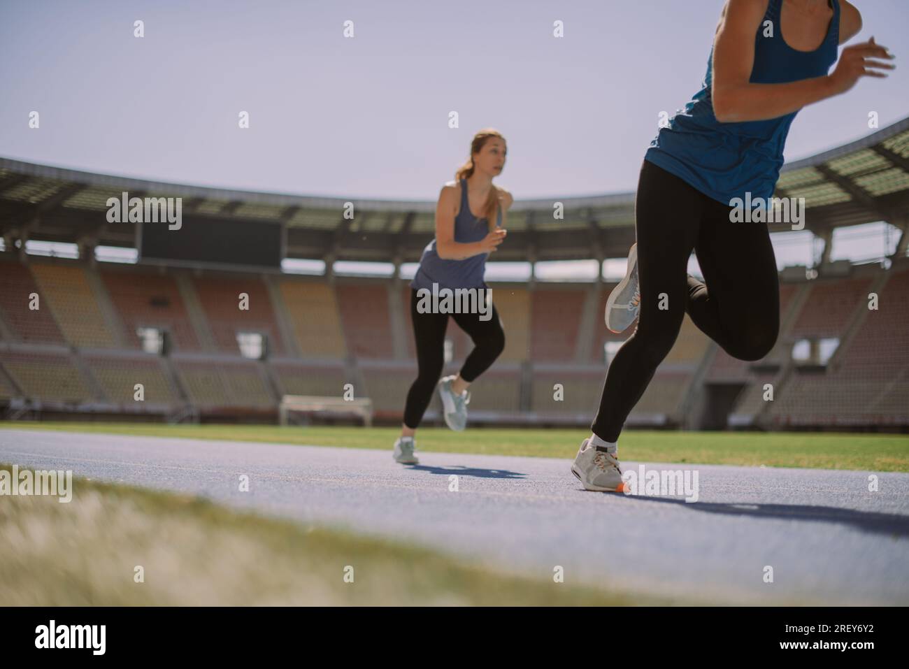 A running marathon is coming. Two girls are training their cardio at ...