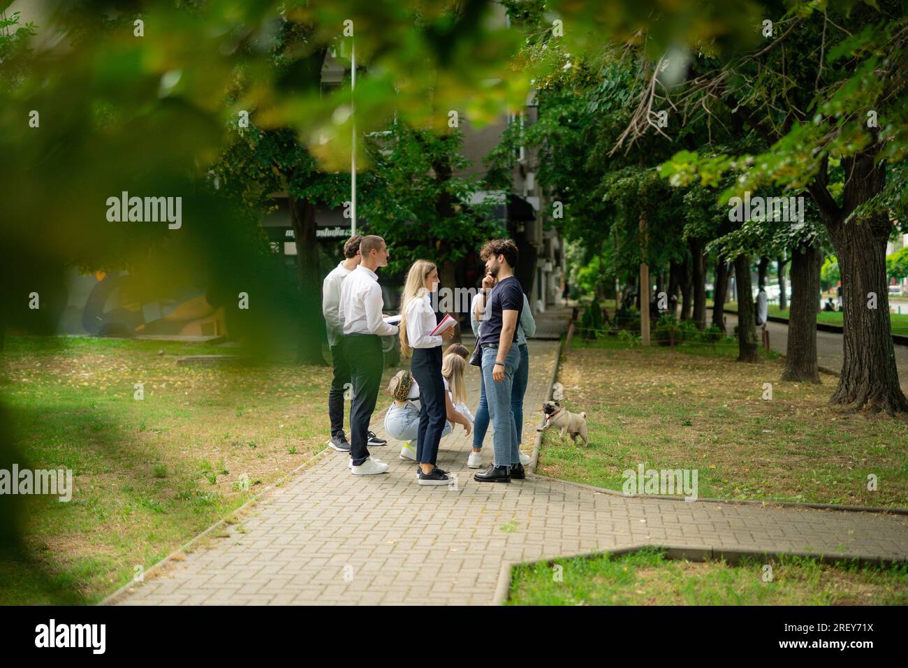 Group of teenage high school students standing outside, talking and ...