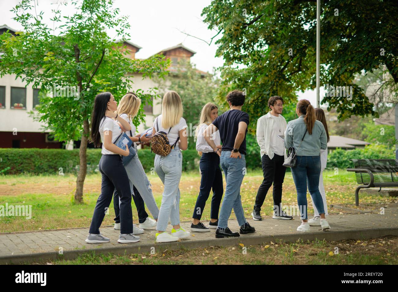 Group of teenage high school students standing outside , talking and ...
