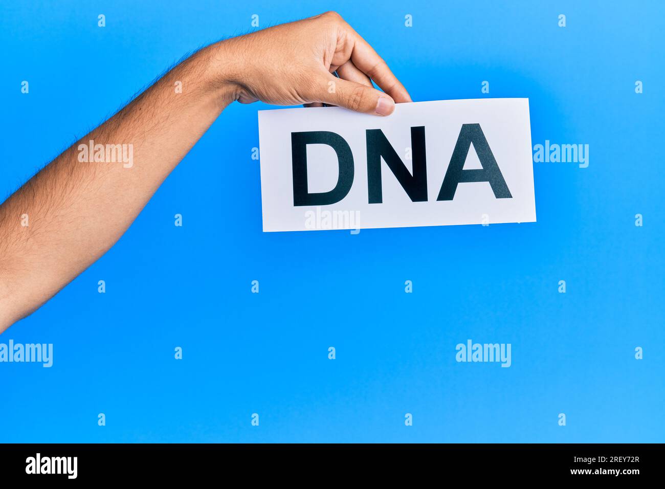 Hand of caucasian man holding paper with dna word over isolated white ...