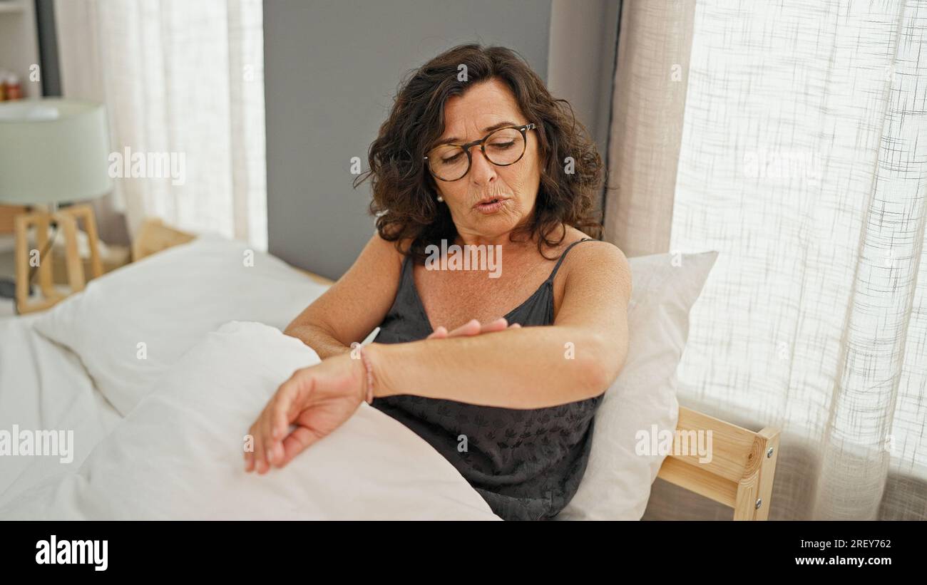 Middle age hispanic woman scratching hi-res stock photography and ...