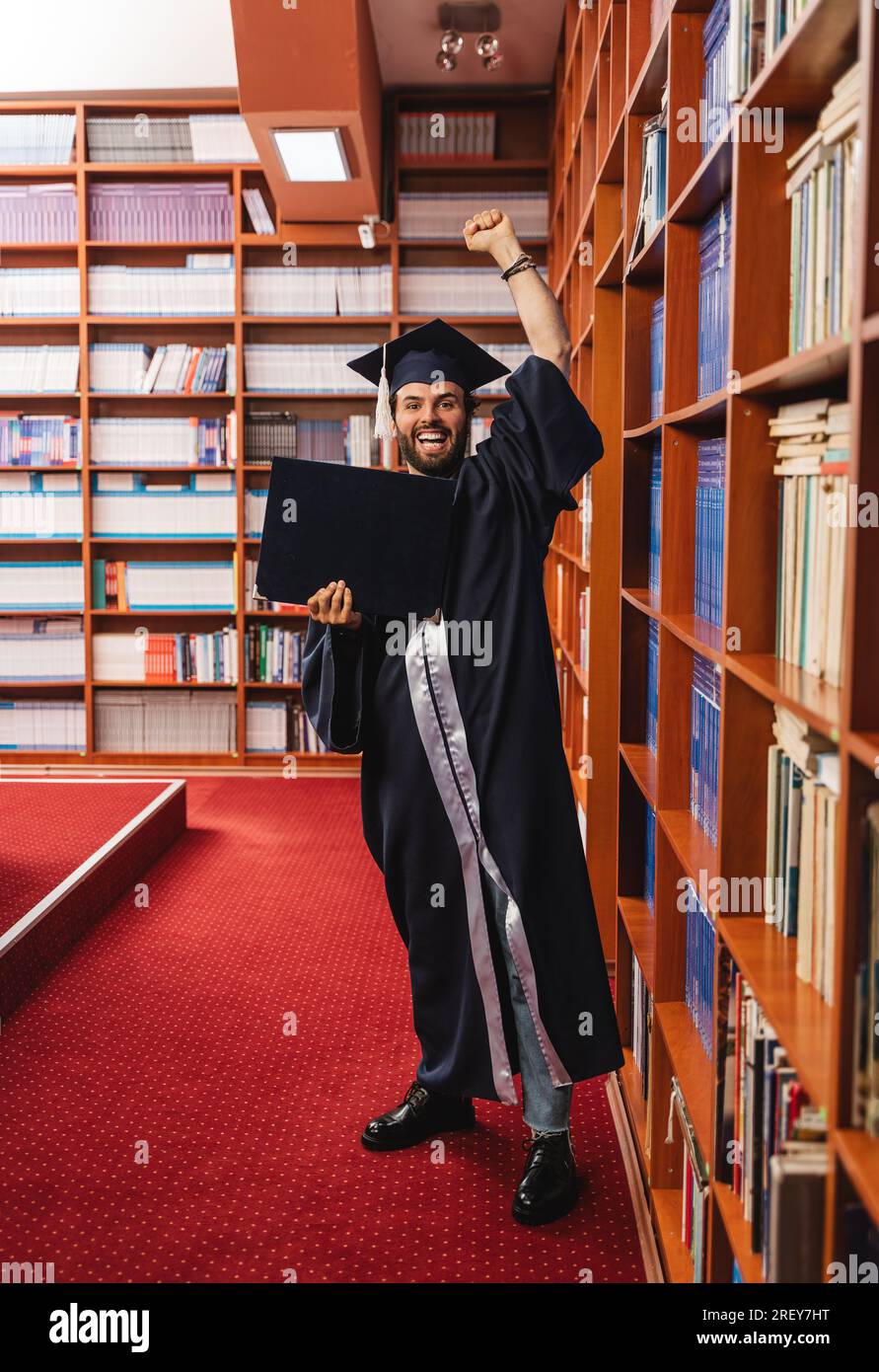 Young and excited graduate celebrating his graduation and receiving his ...